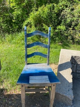 Solve Blue chair at bus stop jigsaw puzzle online with 20 pieces